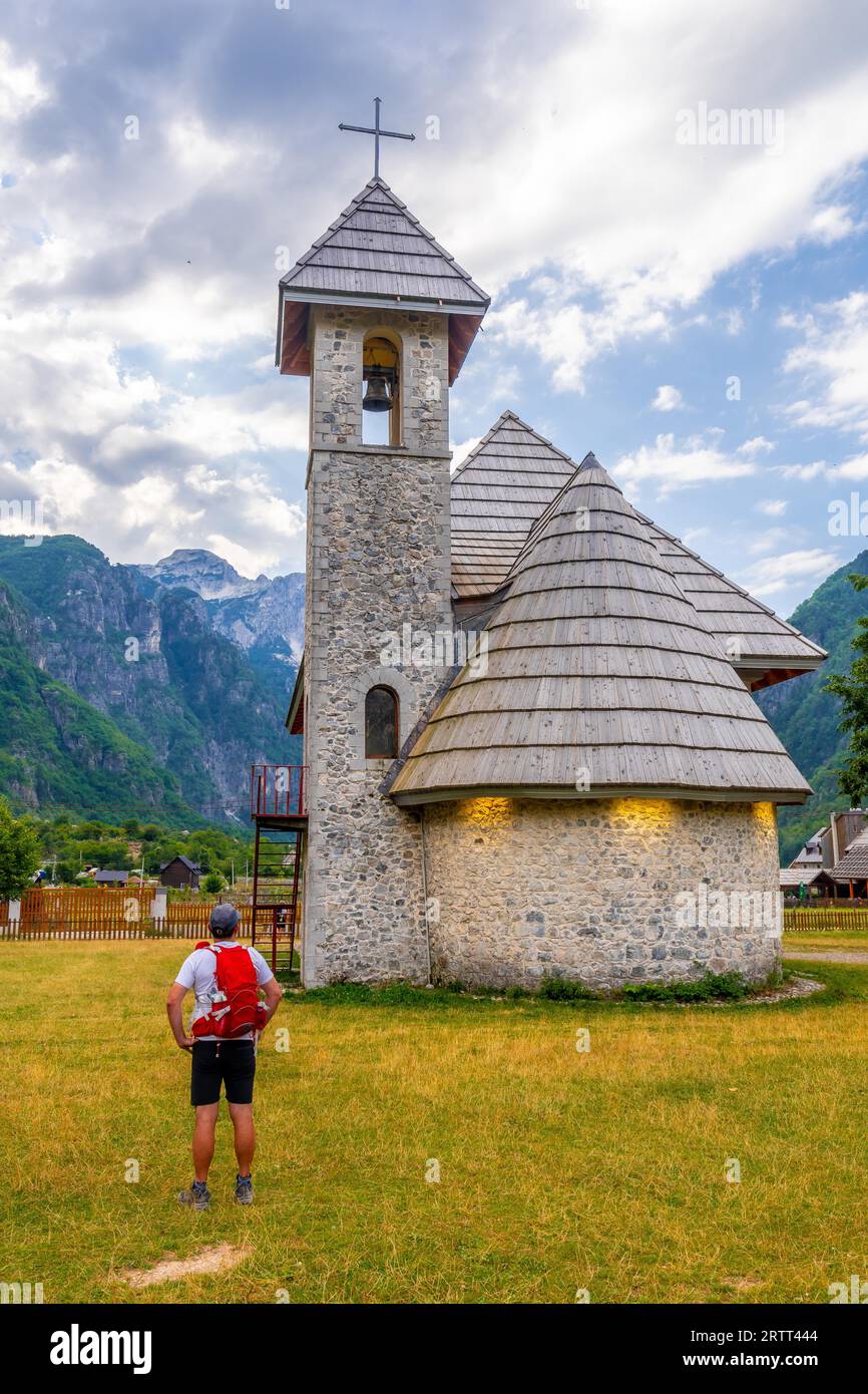 A tourist at the Catholic Church in the valley of Theth national park ...