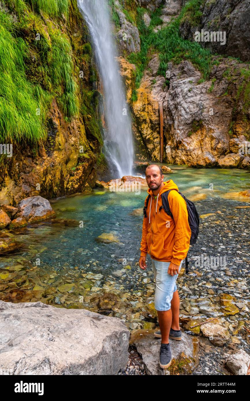 Hiker at Grunas waterfall in Theth national park, Albania. Albanian ...