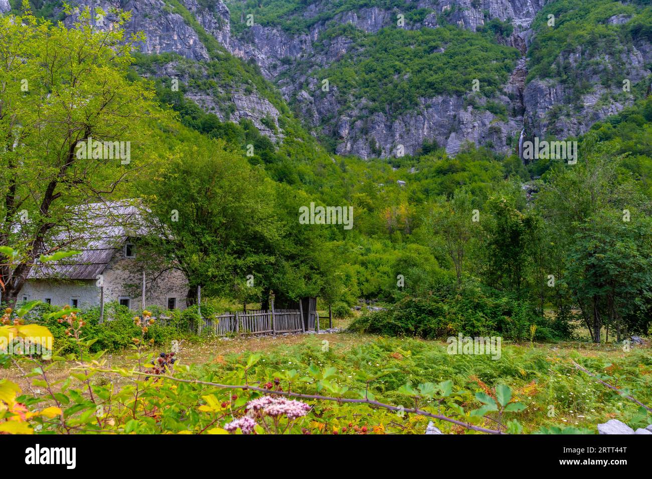 A wooden cabin under the Grunas waterfall in Theth National Park ...
