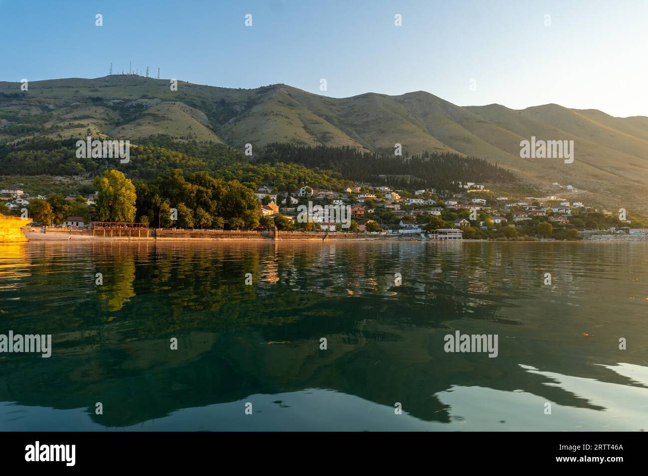 View of the city of Shiroka from the lake on a traditional boat on a ...