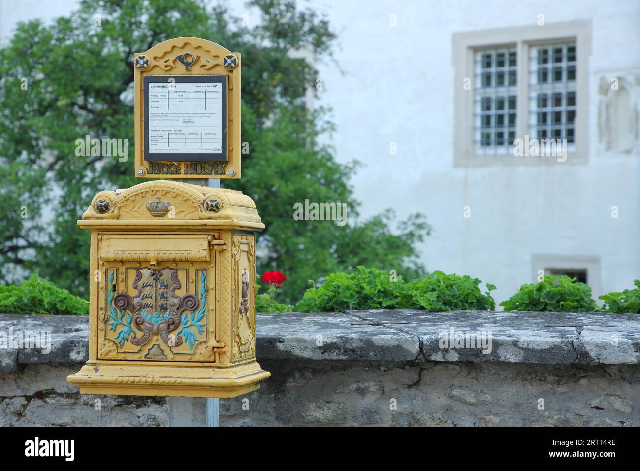 Historical yellow mailbox with ornaments, window with grille, Deutsche ...