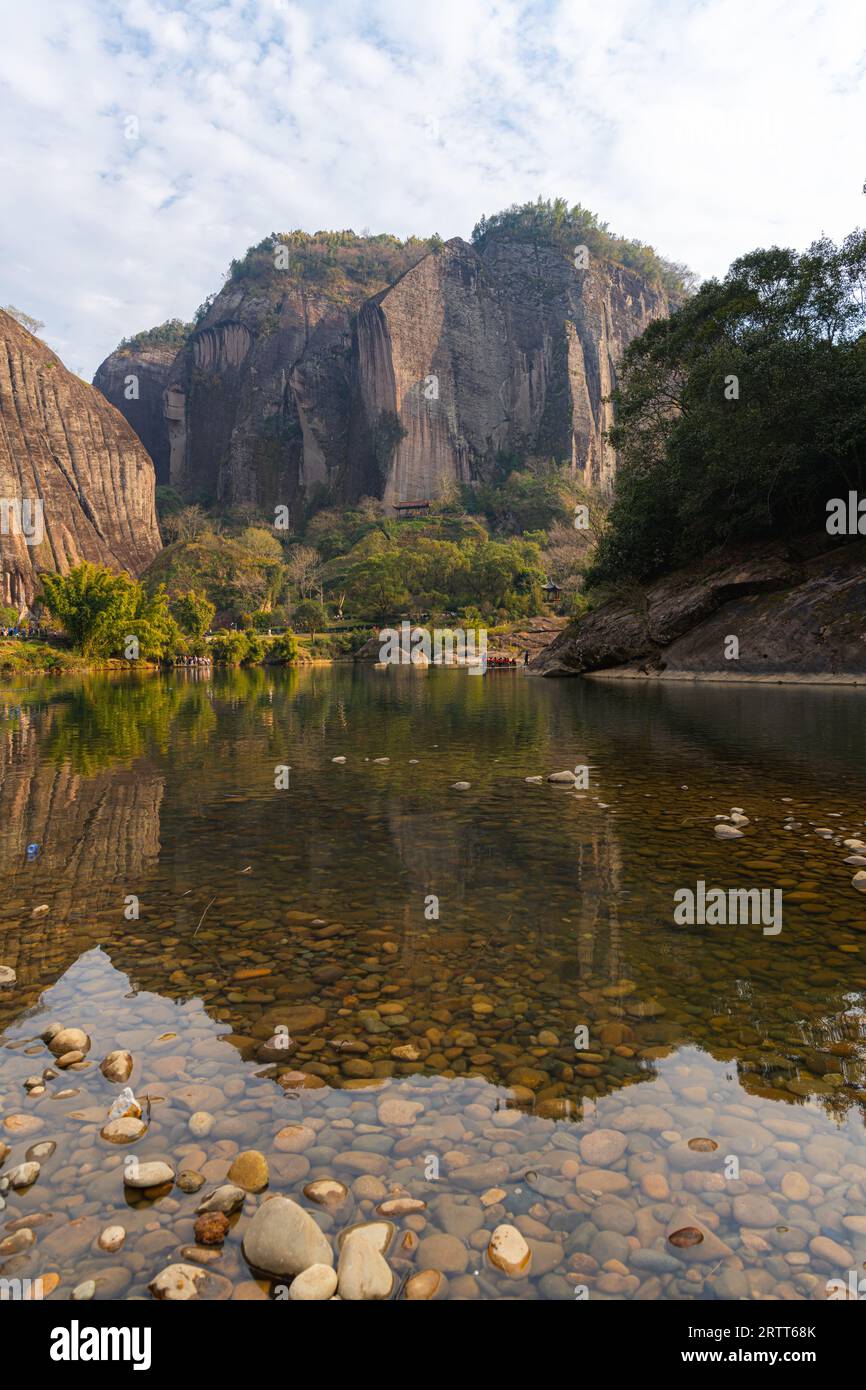 Rocks on the shore and strange shaped mountains of Wuyishan, China ...