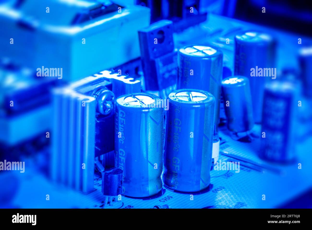 Capacitors om a microcircuit board in blue color Stock Photo - Alamy