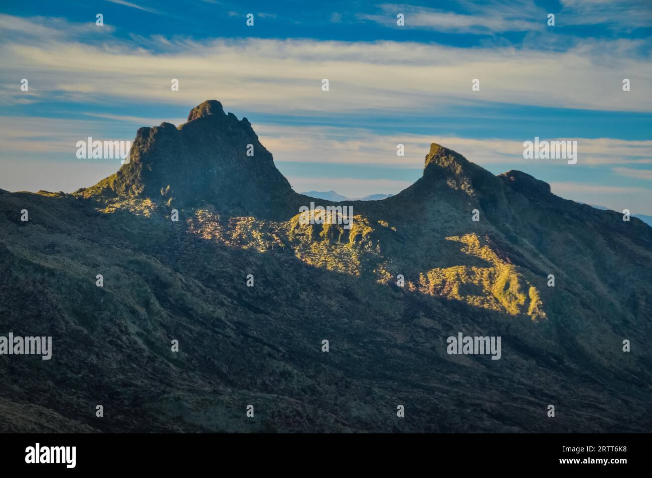 Peaks of Mt. Giluwe in Papua New Guinea in evening light. In this ...