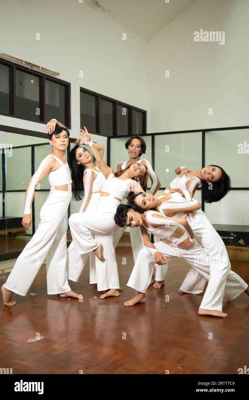 a group of Asian dancers taking funny photos with their friends at the ...