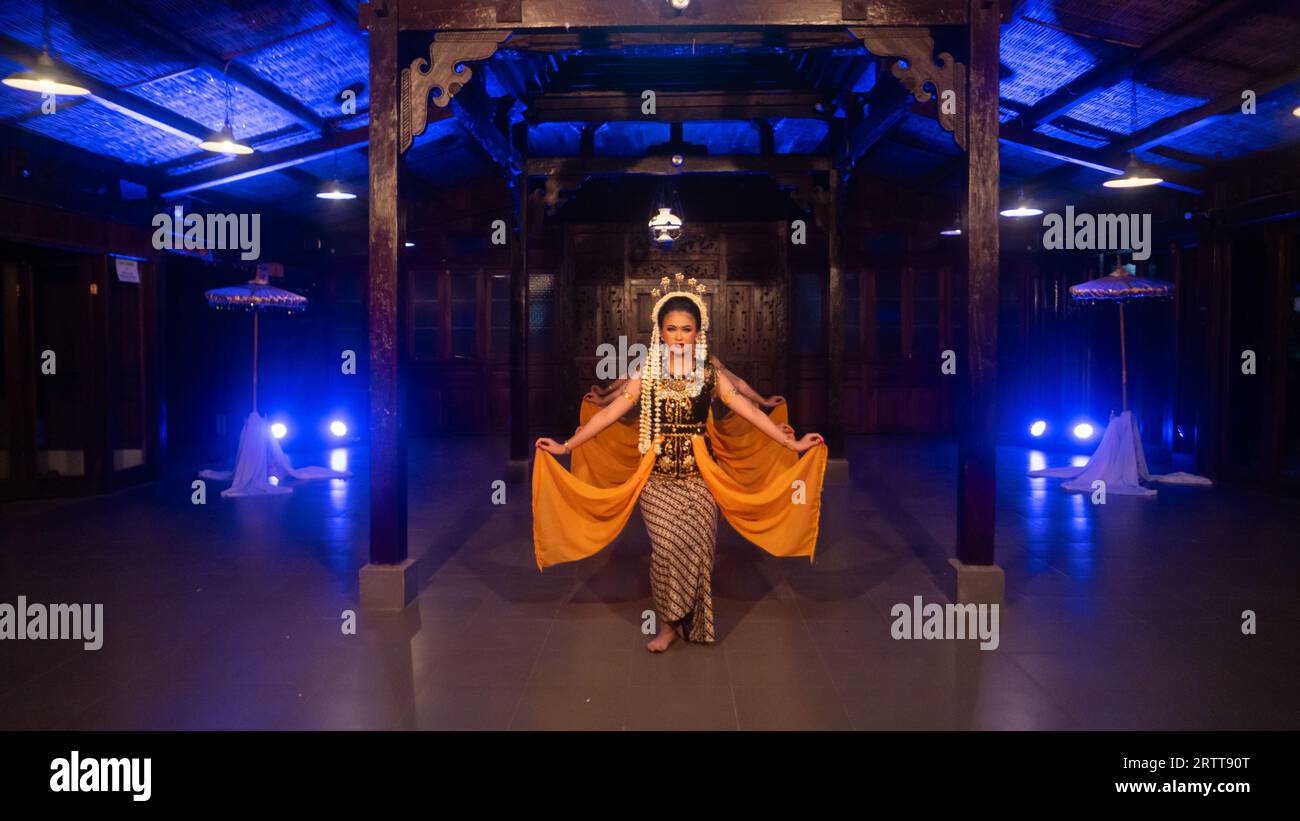 a group of Javanese dancers with their faces full of makeup and jasmine ...