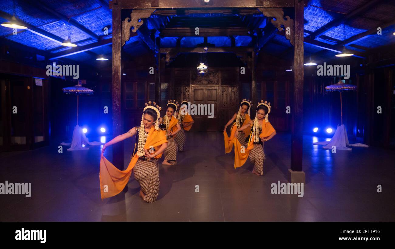 a group of Javanese dancers with their faces full of makeup and jasmine ...