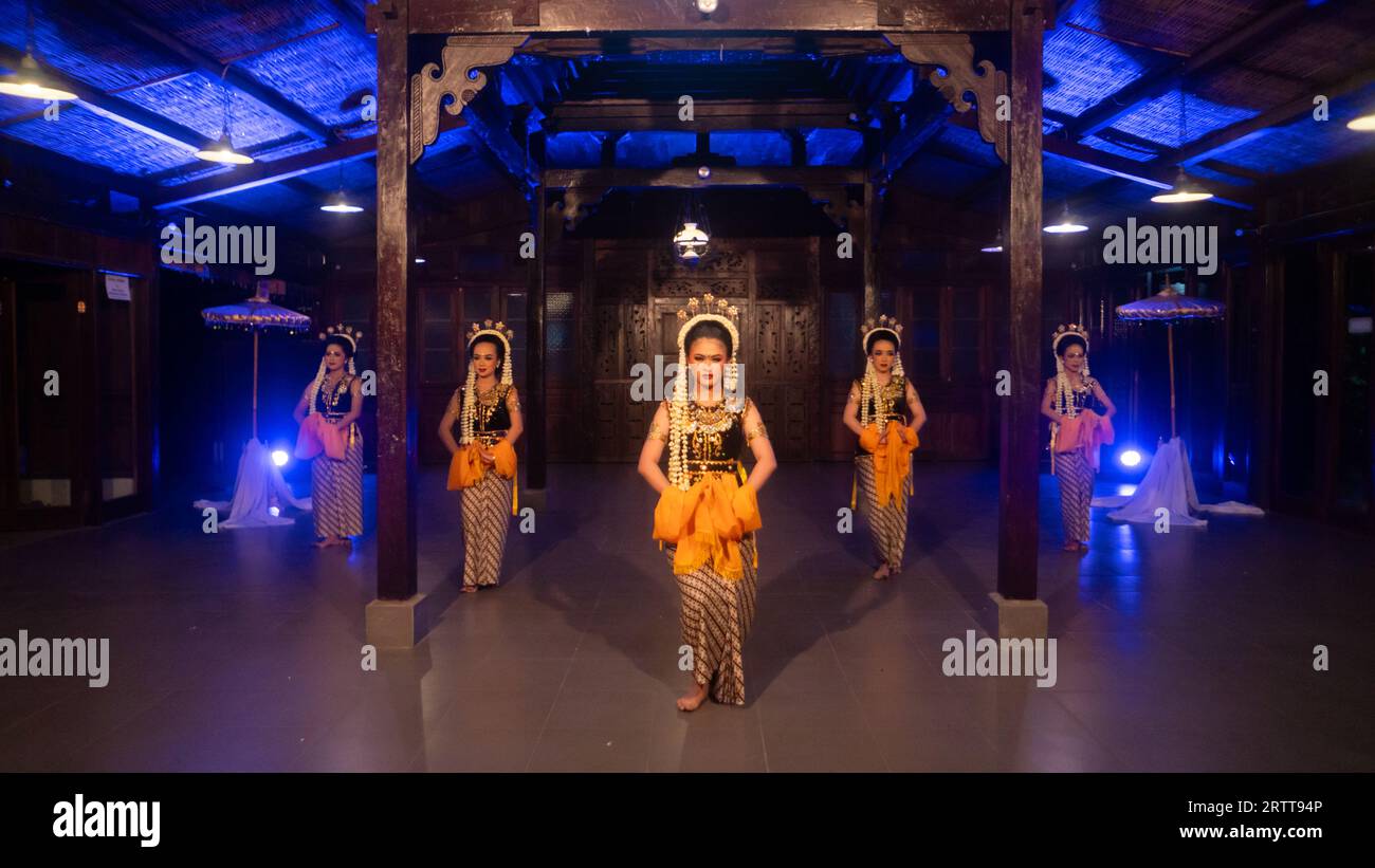 a group of Javanese dancers with their faces full of makeup and jasmine ...