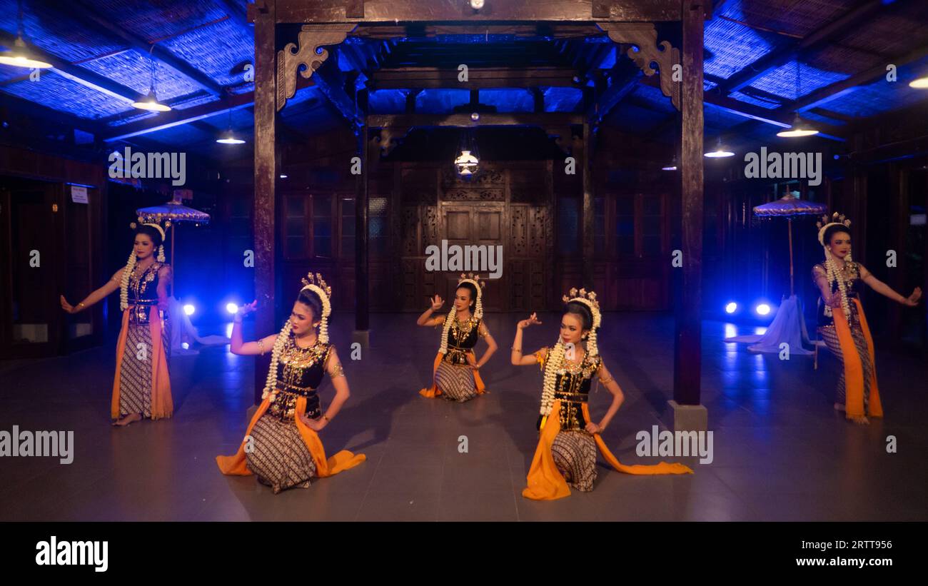 a group of Javanese dancers with their faces full of makeup and jasmine ...