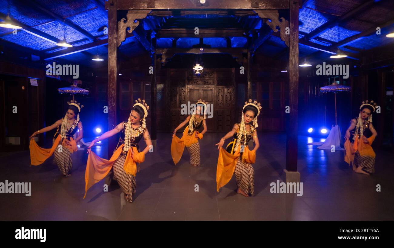 a group of Javanese dancers with their faces full of makeup and jasmine ...