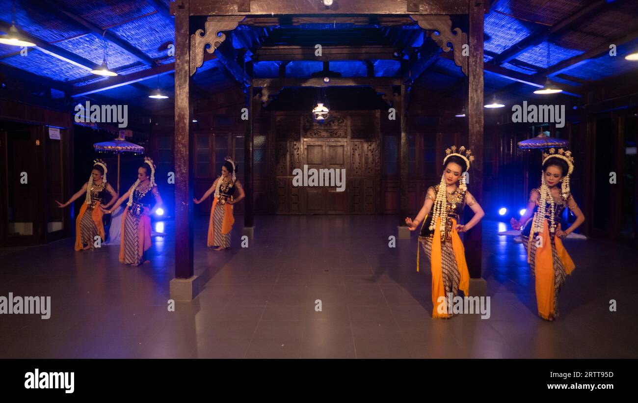 a group of Javanese dancers with their faces full of makeup and jasmine ...