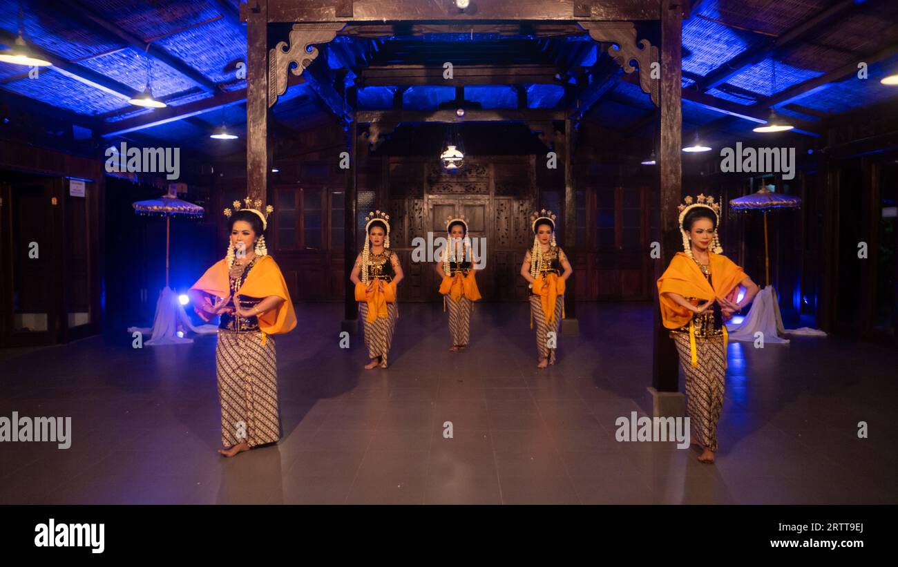 a group of Javanese dancers are dancing a traditional dance in an old ...