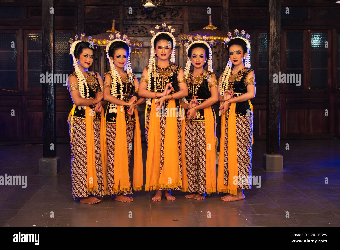 a group of Javanese dancers standing with their friends while wearing ...