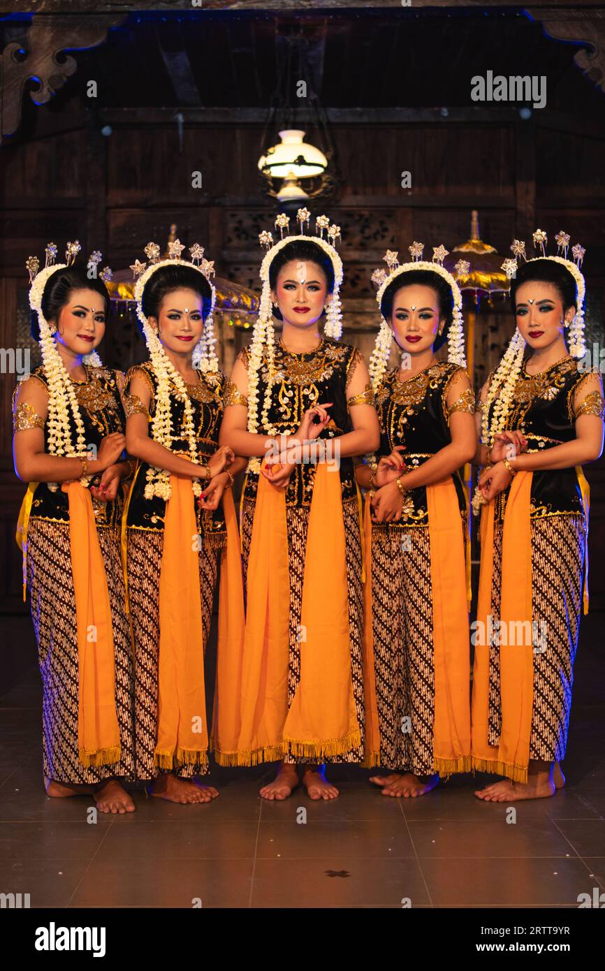 a group of Javanese dancers standing with their friends while wearing ...