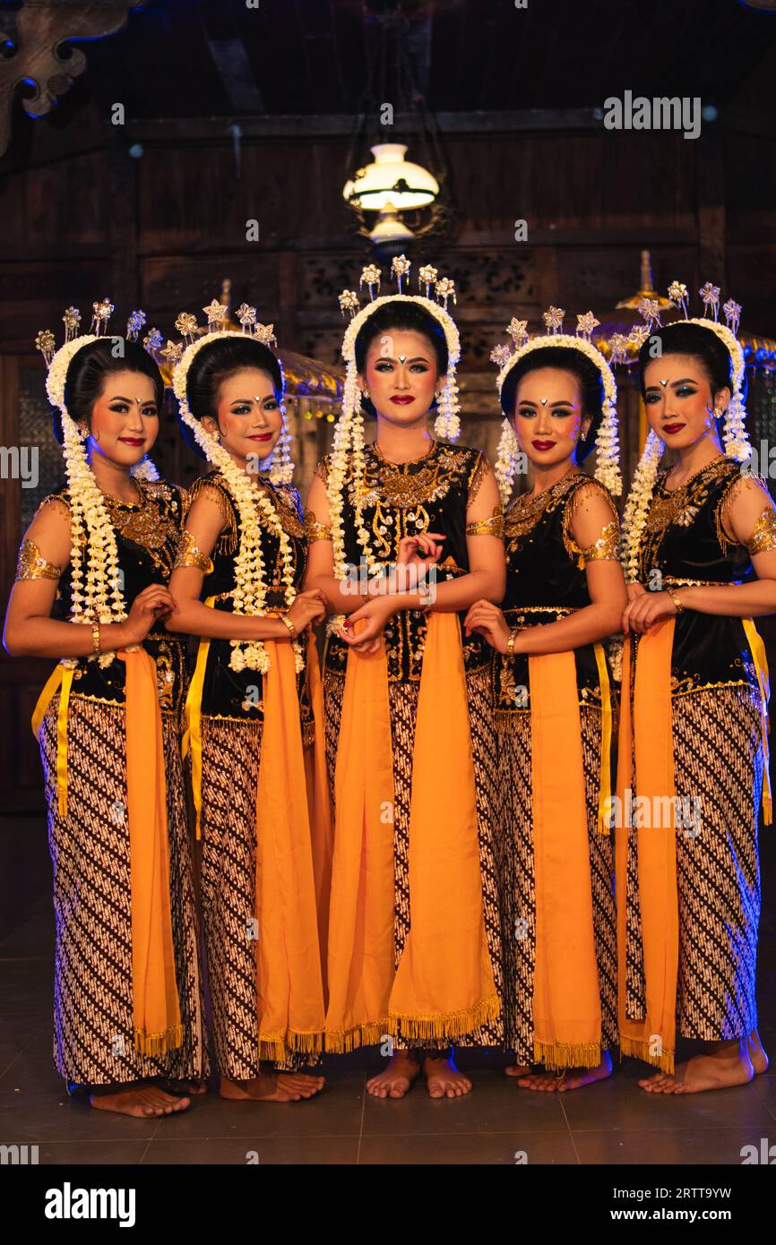 a group of Javanese dancers standing with their friends while wearing ...