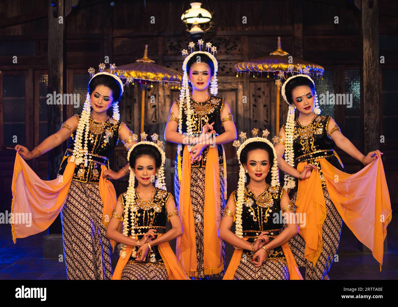a group of Javanese dancers poses dancing with their friends while ...