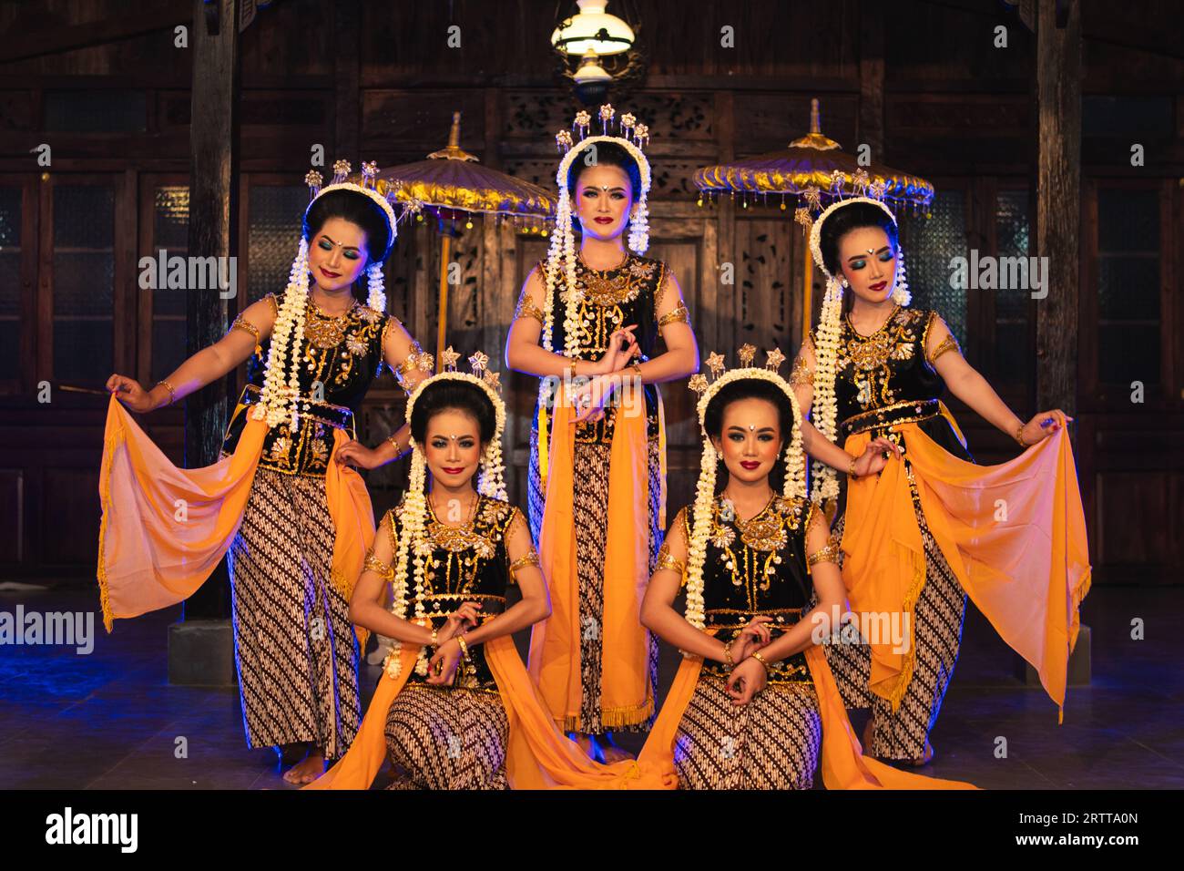 a group of Javanese dancers poses dancing with their friends while ...