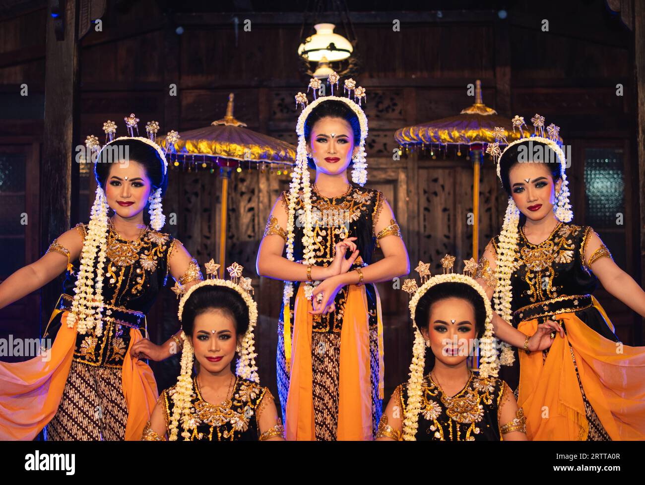 a group of Javanese dancers poses dancing with their friends while ...