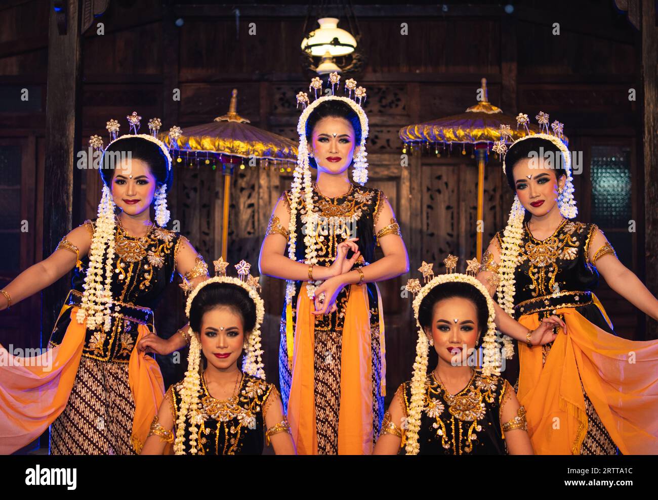 a group of Javanese dancers poses dancing with their friends while ...