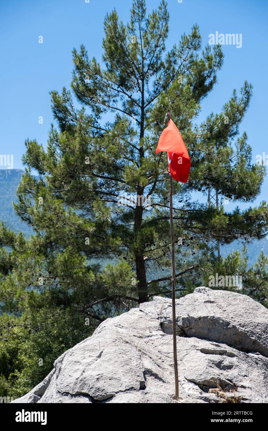 The Turkish flag is flying against the backdrop of beautiful mountains ...