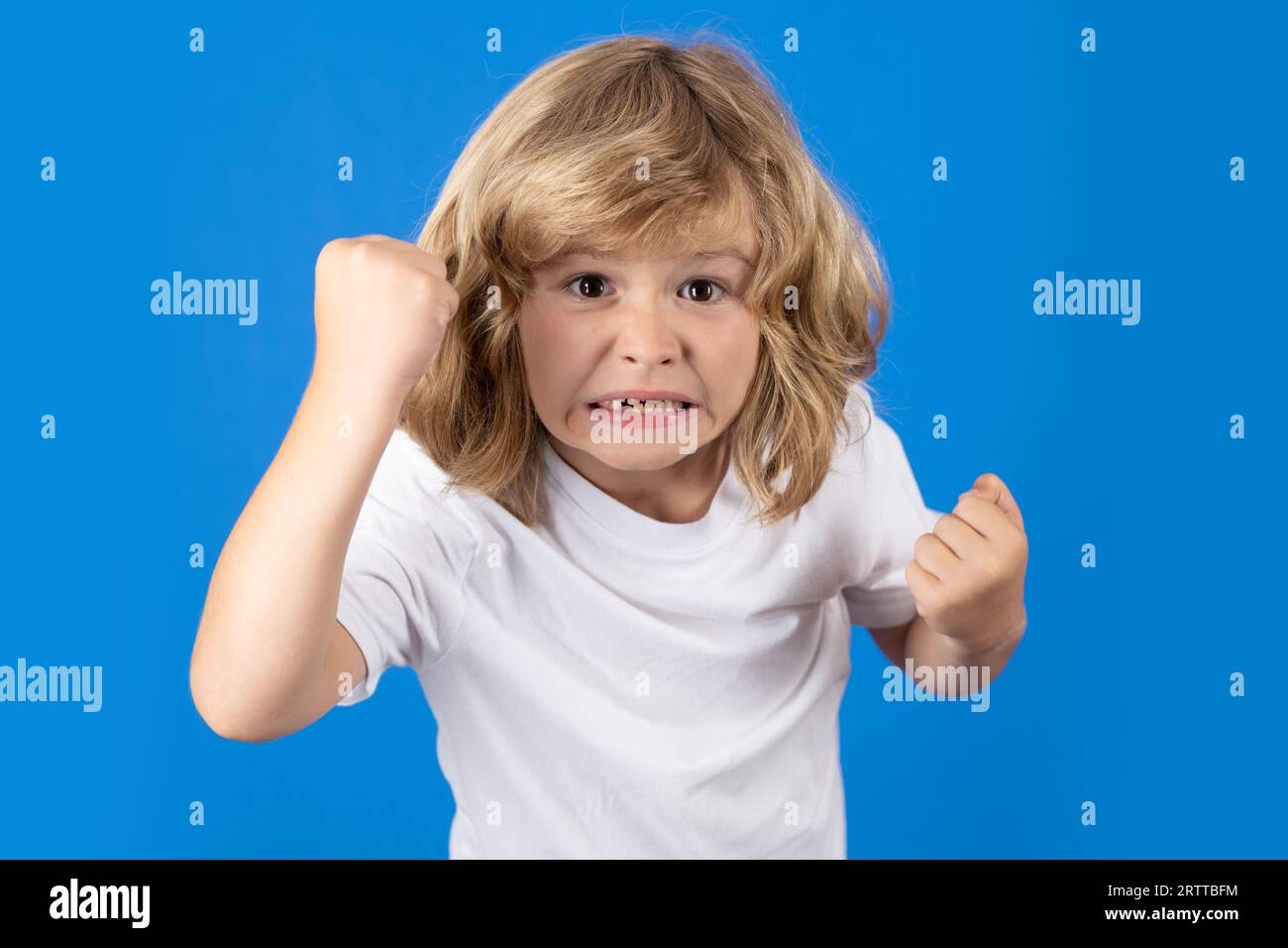 Child with angry expression in studio. Angry hateful little boy, child furious. Angry rage kids ...