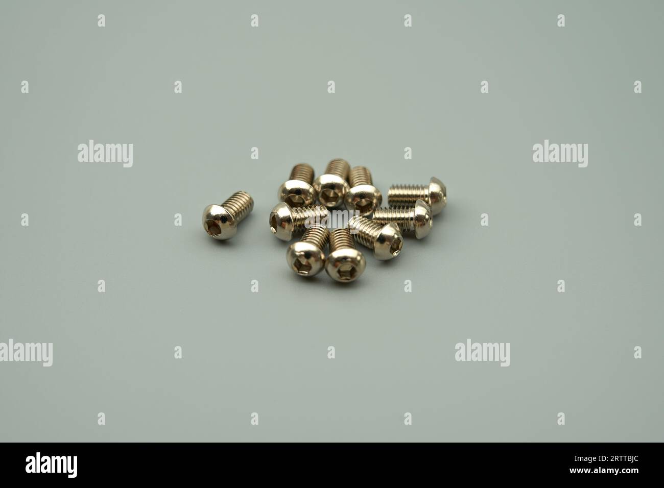 Stainless steel flat head hex bolt, gray background Stock Photo - Alamy