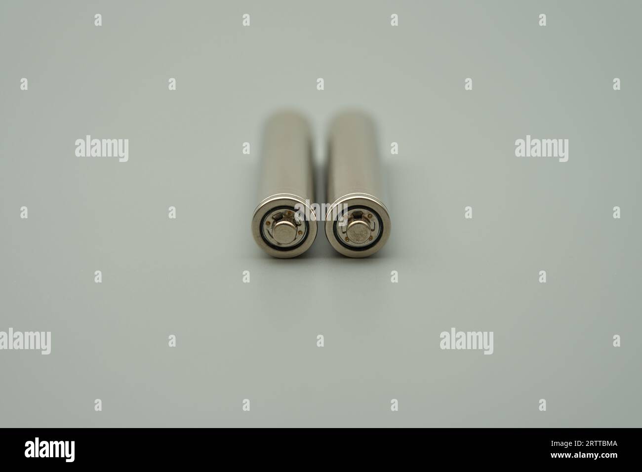 The head of an AAA 1.2V rechargeable battery with the outer casing ...