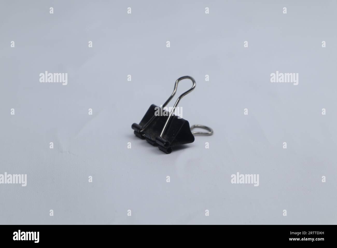 black paper clip isolated on white background Stock Photo - Alamy
