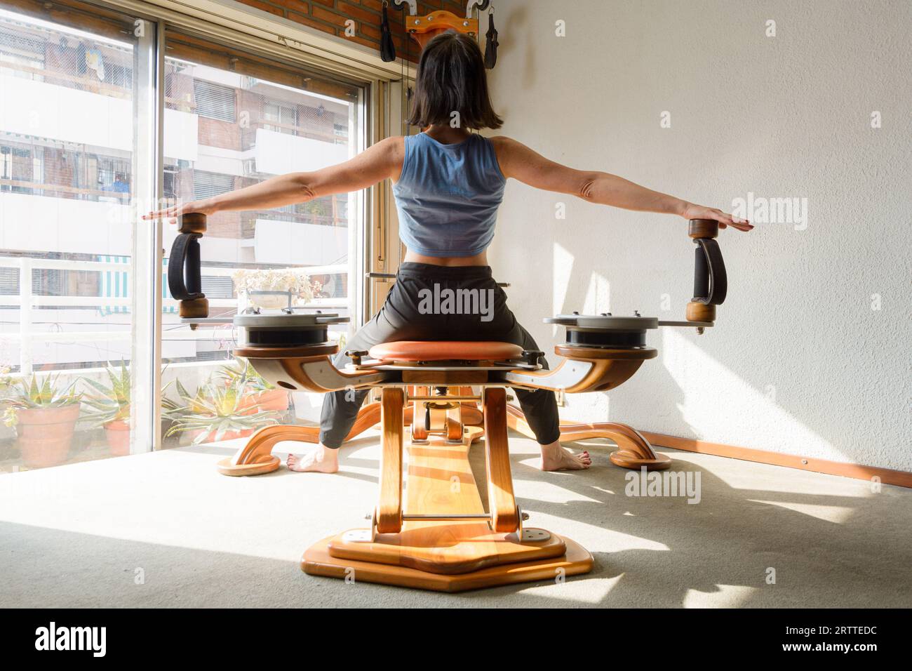 back view of latin woman wearing blue top, sitting working and ...