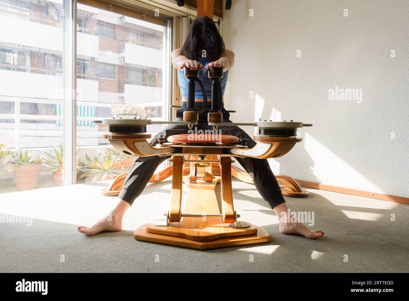 front view of latin woman wearing blue clothes, sitting working and ...