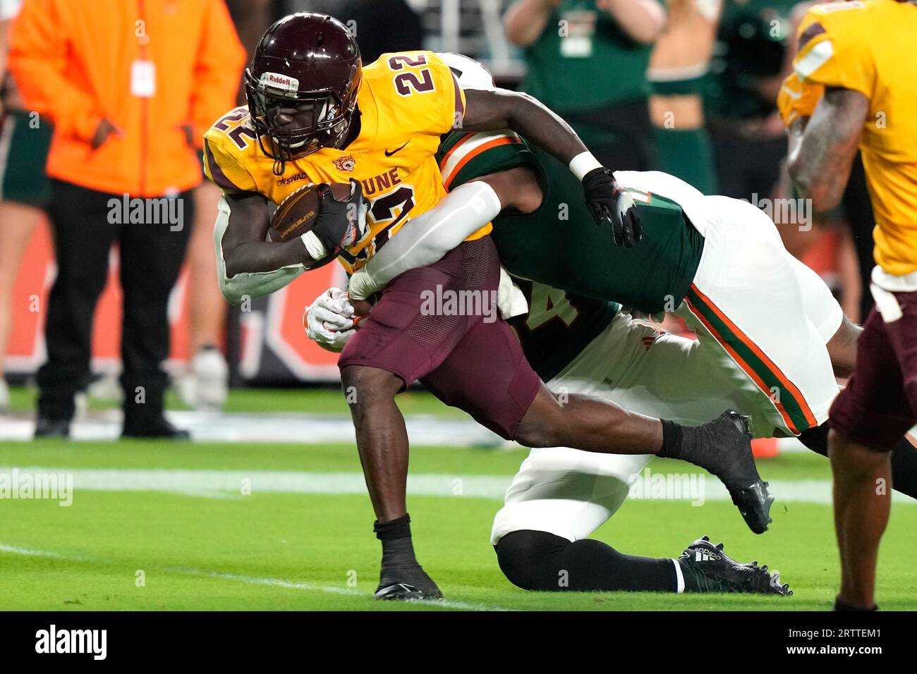 Bethune-Cookman running back Jouvensly Bazil (22) is tackled by Miami ...