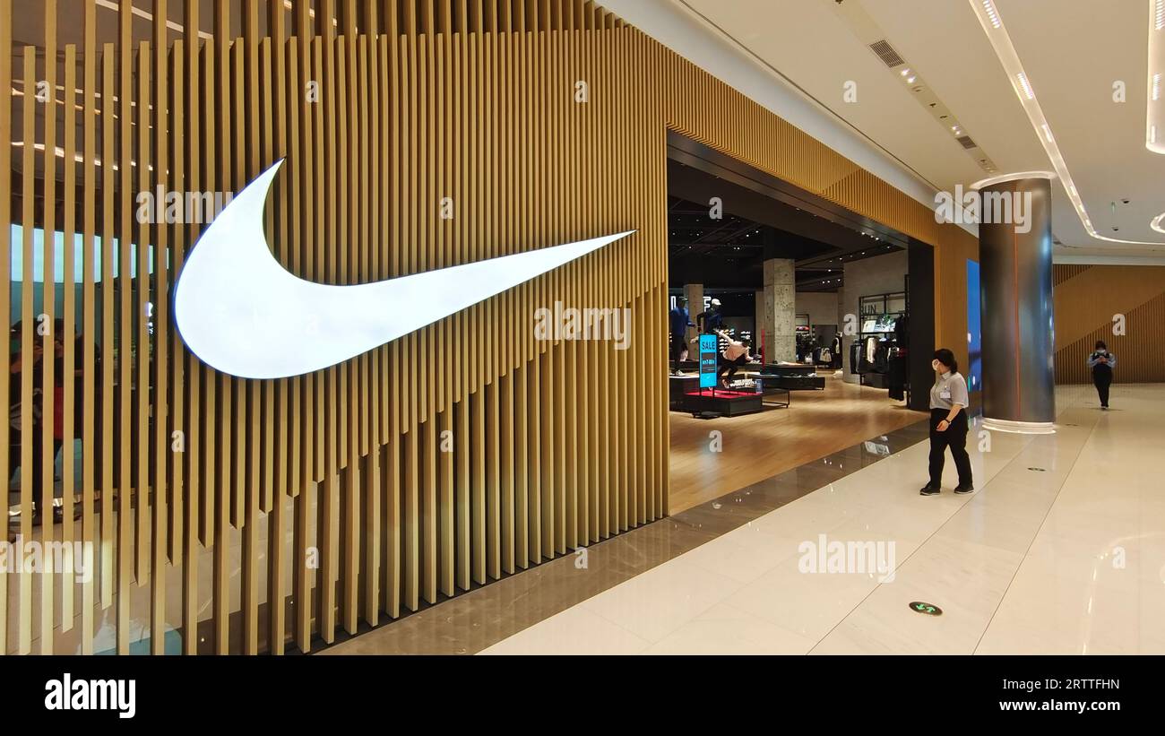 (FILE) People walk past a NIKE store in Shanghai, China, September 29 ...