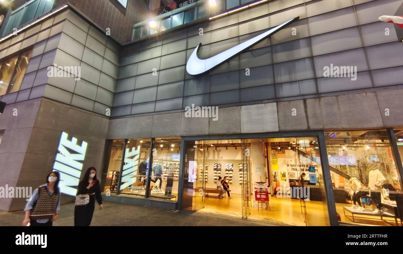 (FILE) People walk past a NIKE store in Shanghai, China, September 29 ...