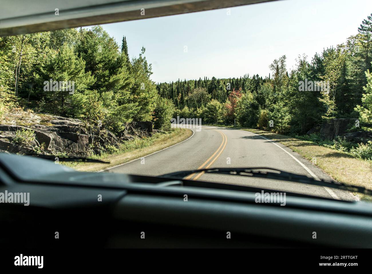 Inside car view POV steering wheel on traffic road with colorful ...