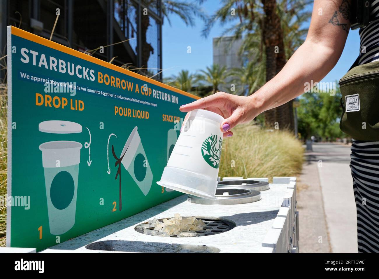 A reusable cup is returned to a borrow a cup return bin at an Arizona ...