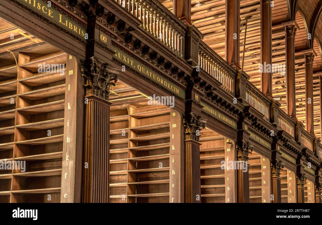 Empty wooden bookshelves in the classic Trinity College library in ...