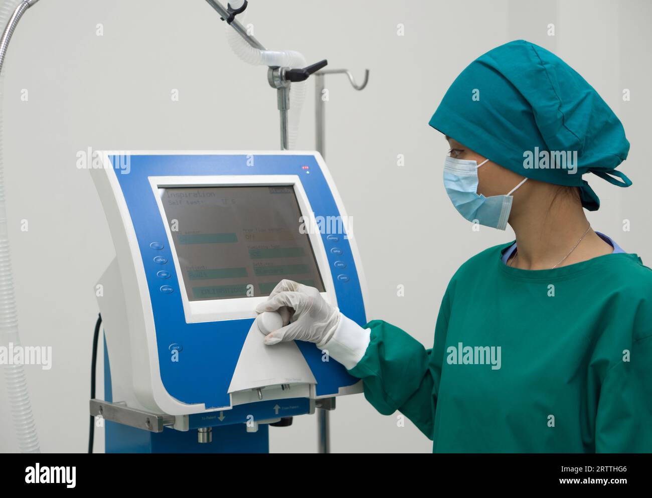 A dedicated healthcare professional in a sterile surgical gown ...