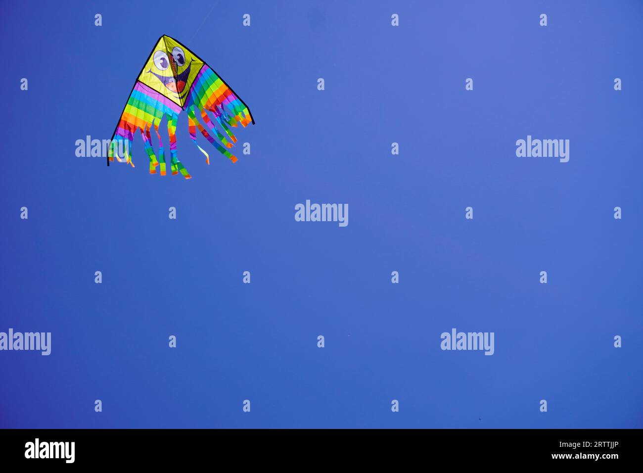 A kite flies in the blue sky Stock Photo - Alamy