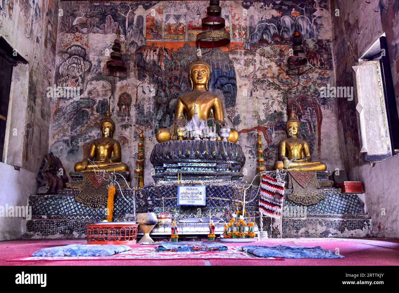 Faded murals, altar and golden Buddha statues in Wat Pa Huak (Monastery ...