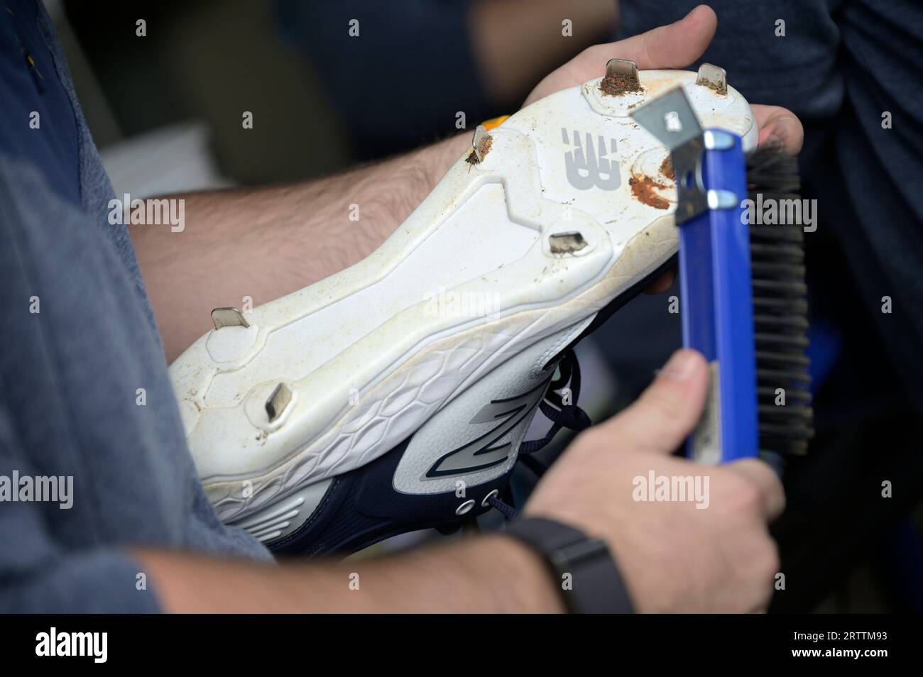 Team staff members clean the cleats of Tampa Bay Rays players in the ...