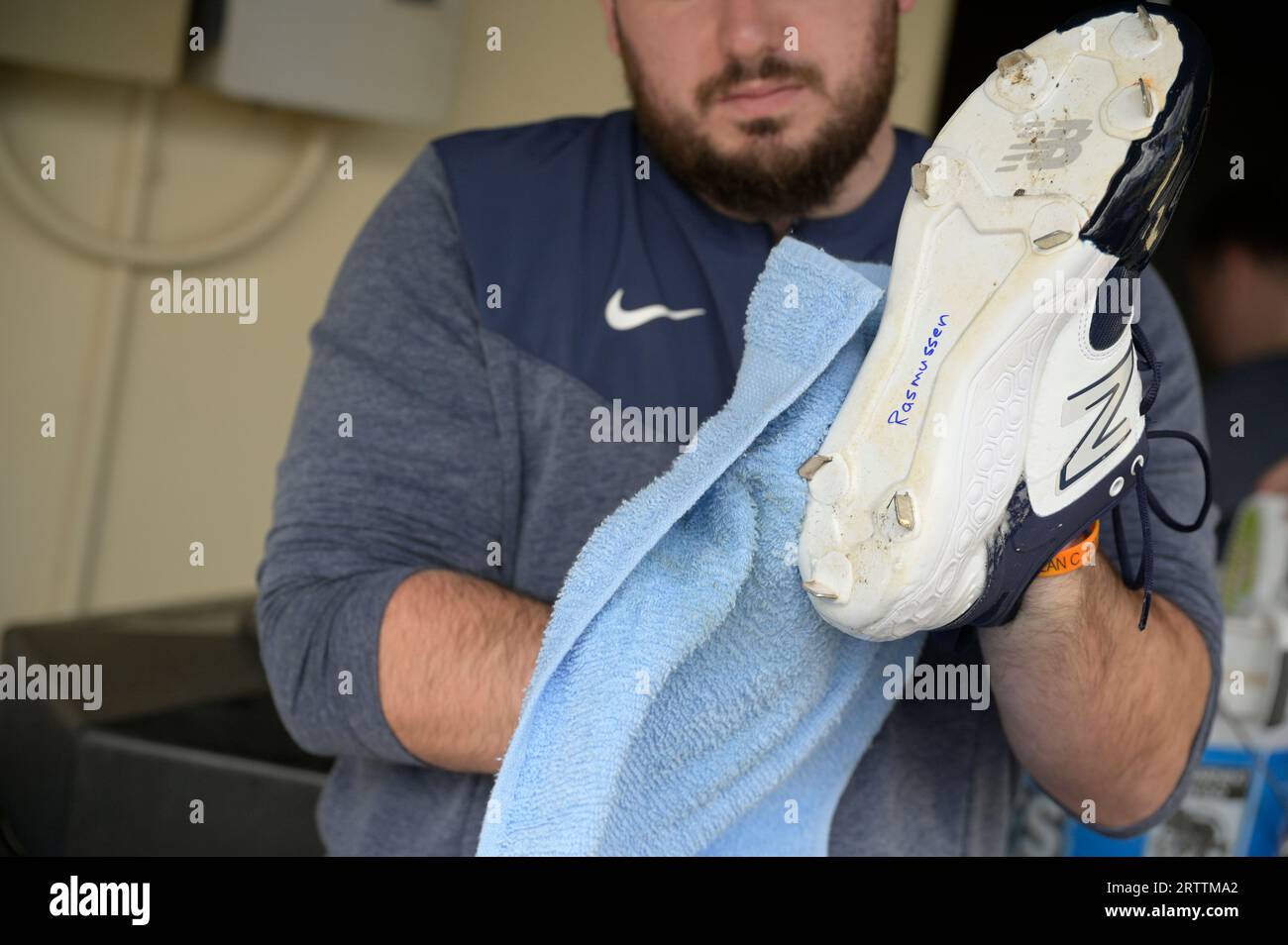 Team staff members clean the cleats of Tampa Bay Rays players in the ...