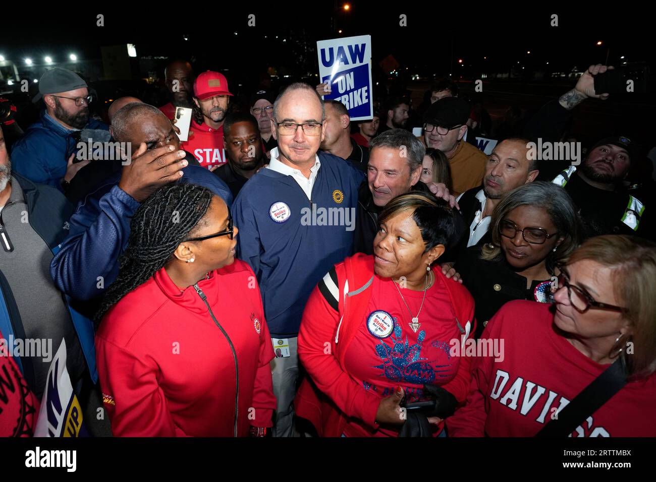 United Auto Workers President Shawn Fain stands with UAW members ...