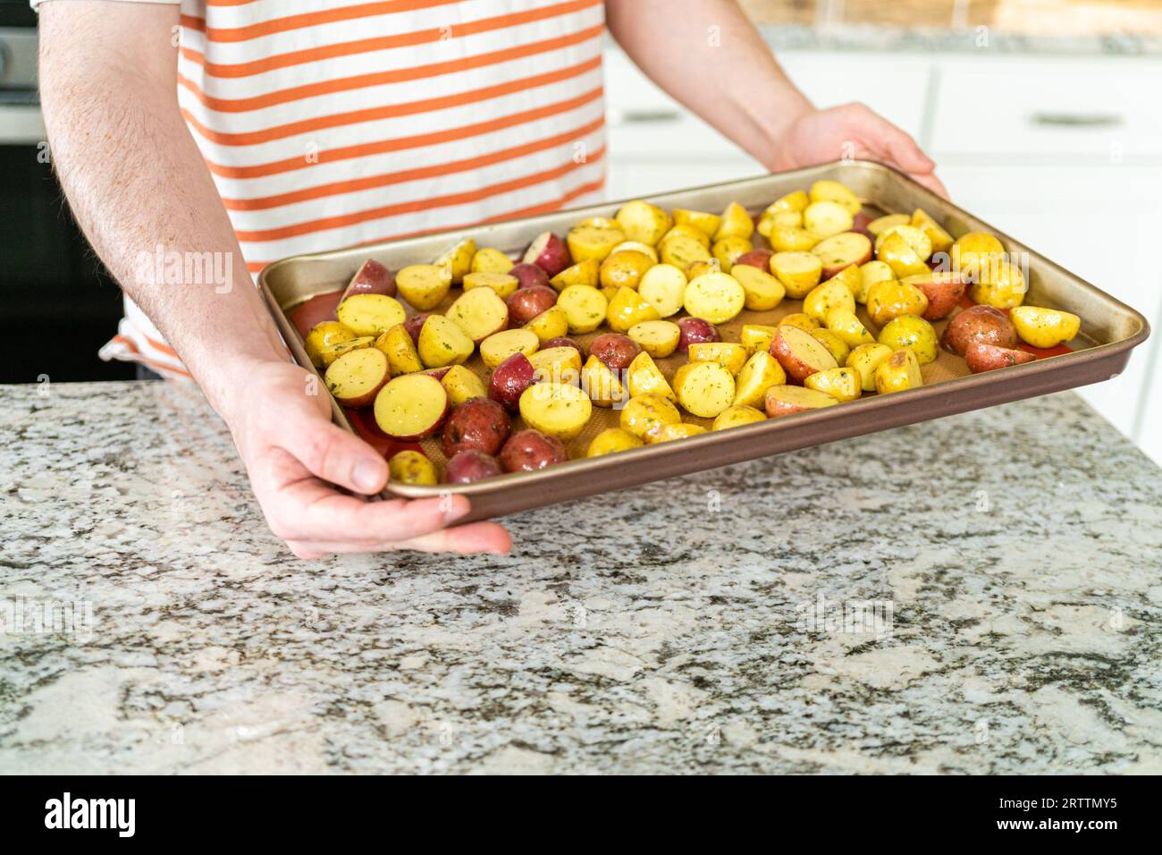 Roasting Halved Mixed Marble Potatoes in Modern Kitchen Stock Photo - Alamy