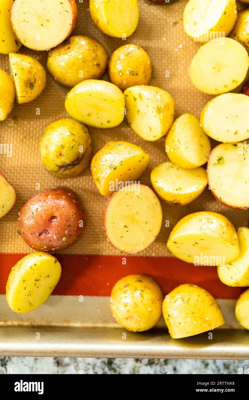 Roasting Halved Mixed Marble Potatoes in Modern Kitchen Stock Photo - Alamy
