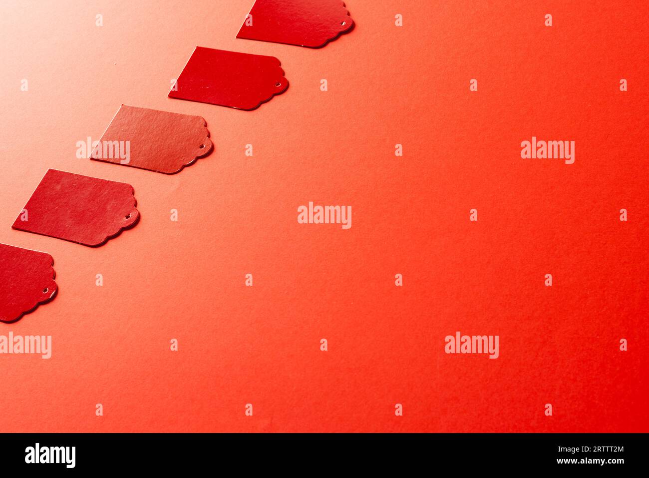Row of red price tags with copy space on red background Stock Photo - Alamy