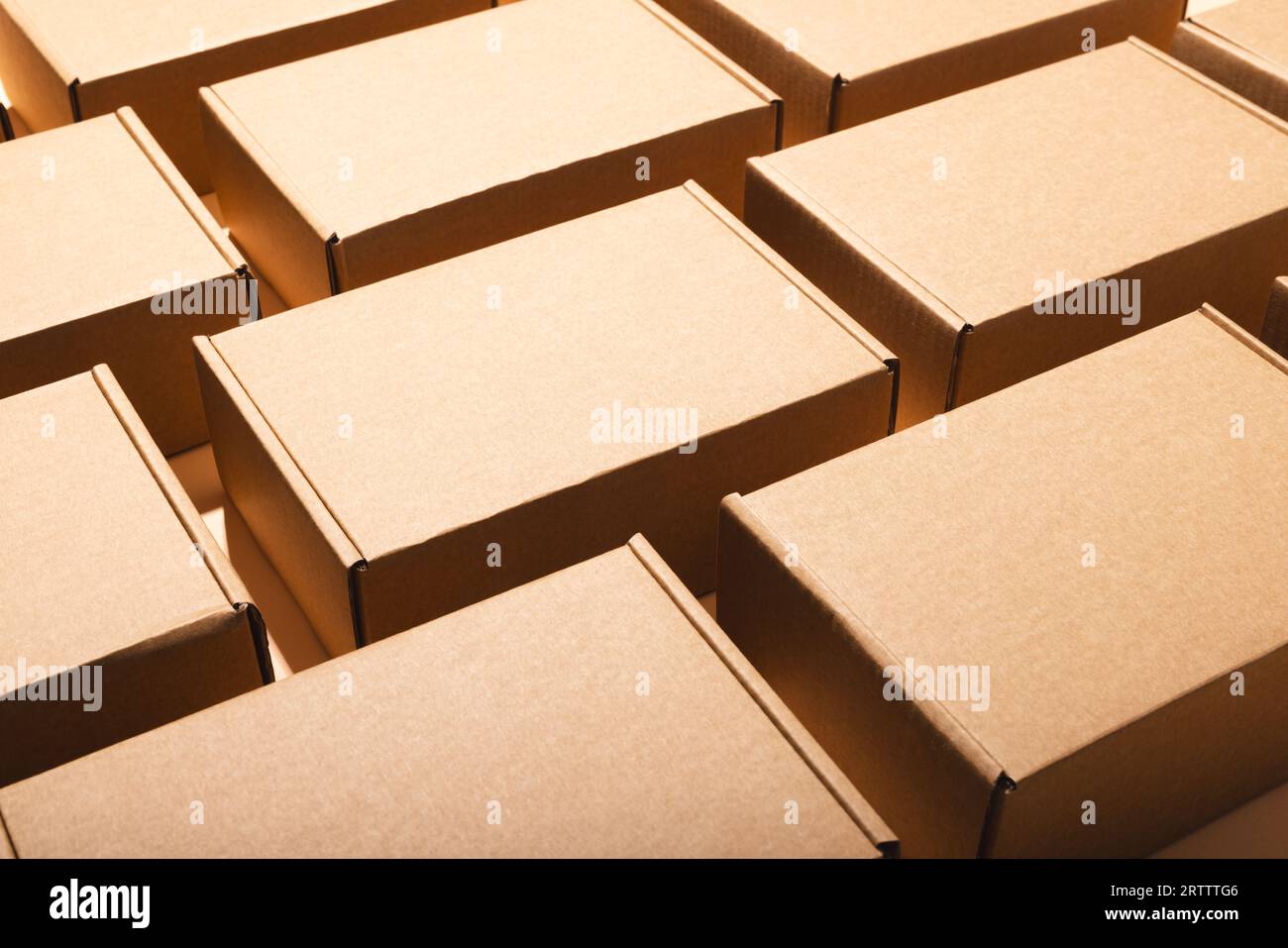 Rows of boxes and copy space over cream background Stock Photo - Alamy