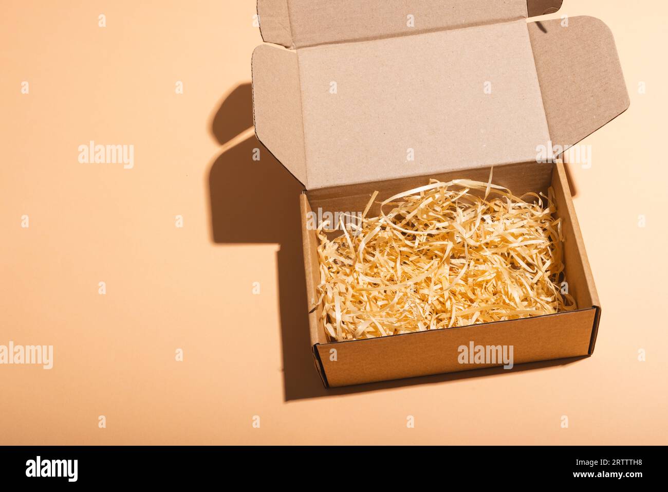 Open box with straw lining and copy space over cream background Stock ...