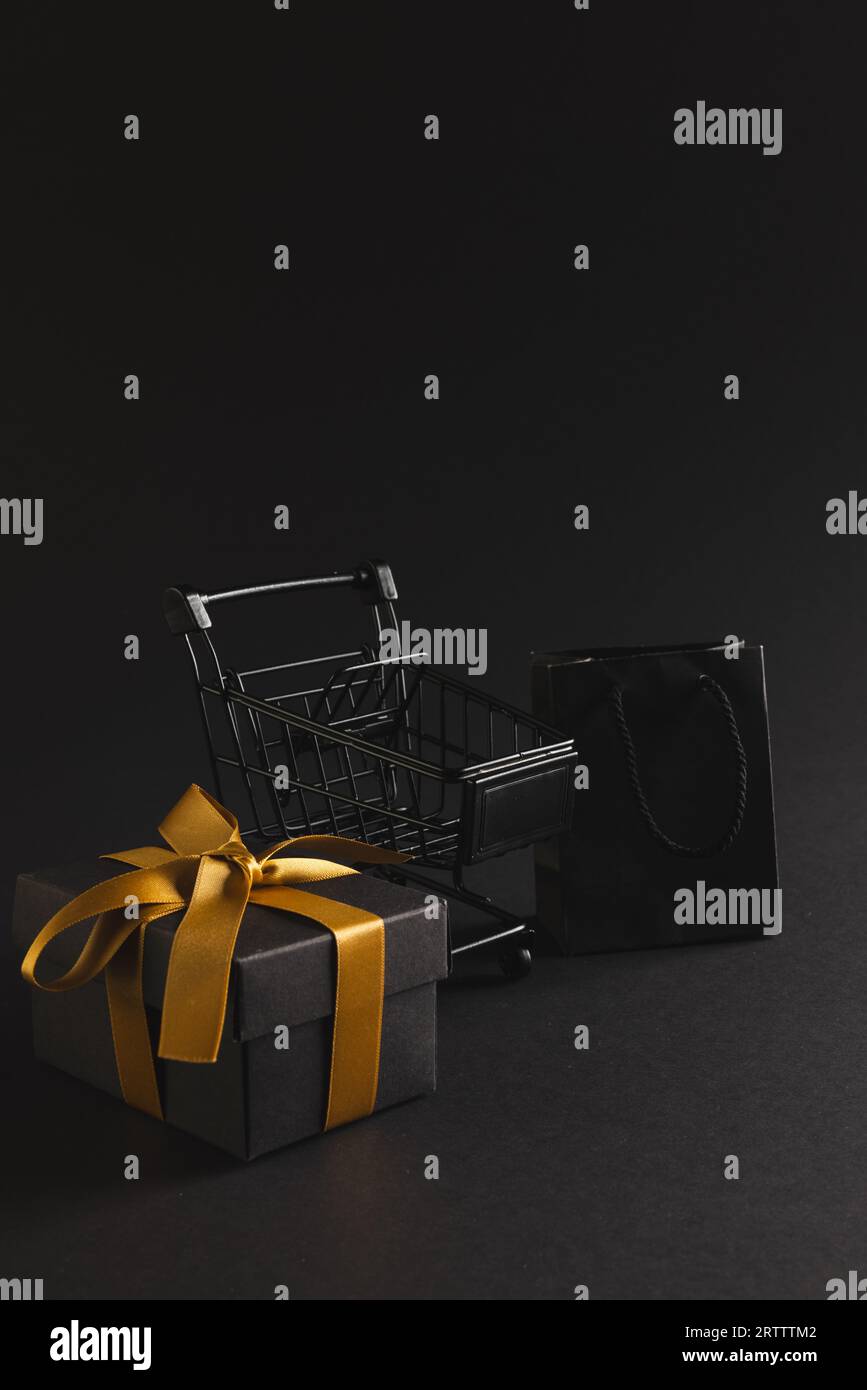 Vertical image of gift box with ribbon, gift bag, shopping trolley ...
