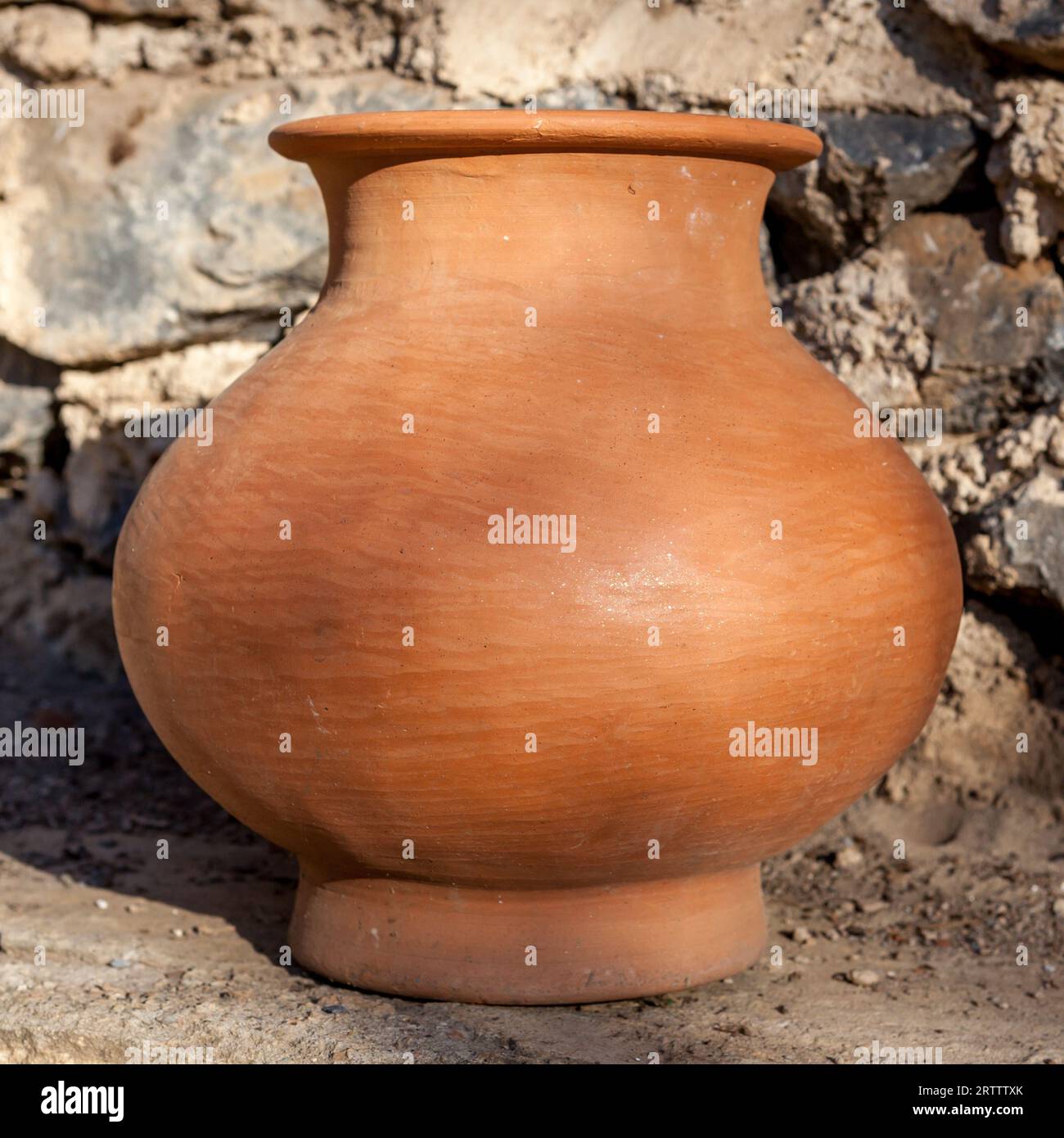 Single traditional Clay Pot with brick wall at background in Myanmar ...