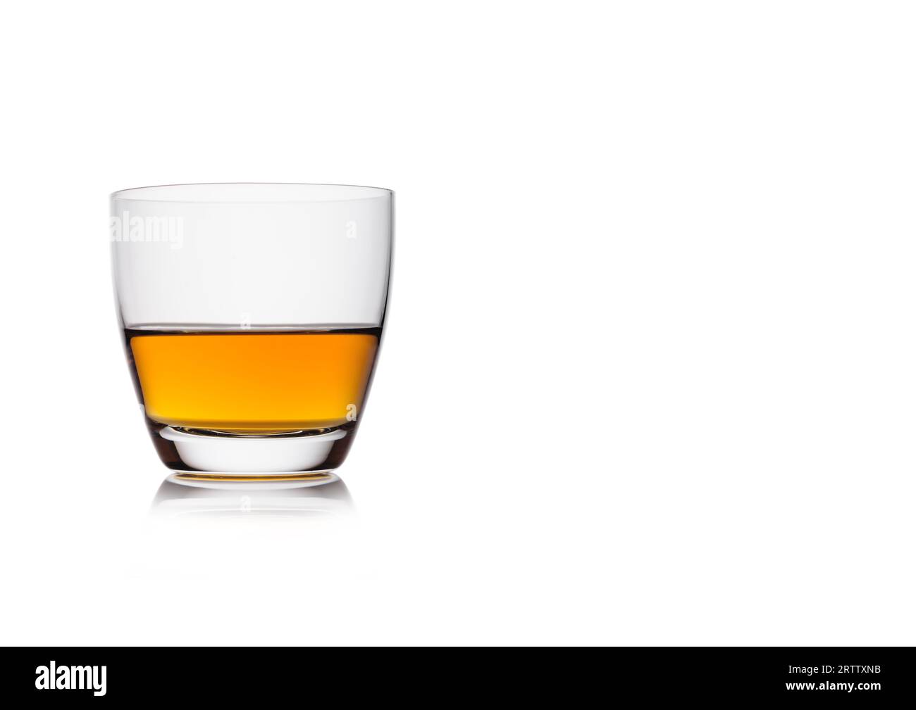 Scotch whiskey in crystal elegant glass on white background. Space for ...